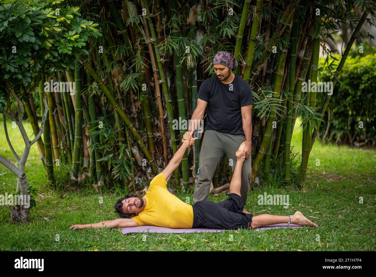 Thai massage therapy session, full body massage with bamboo background ...