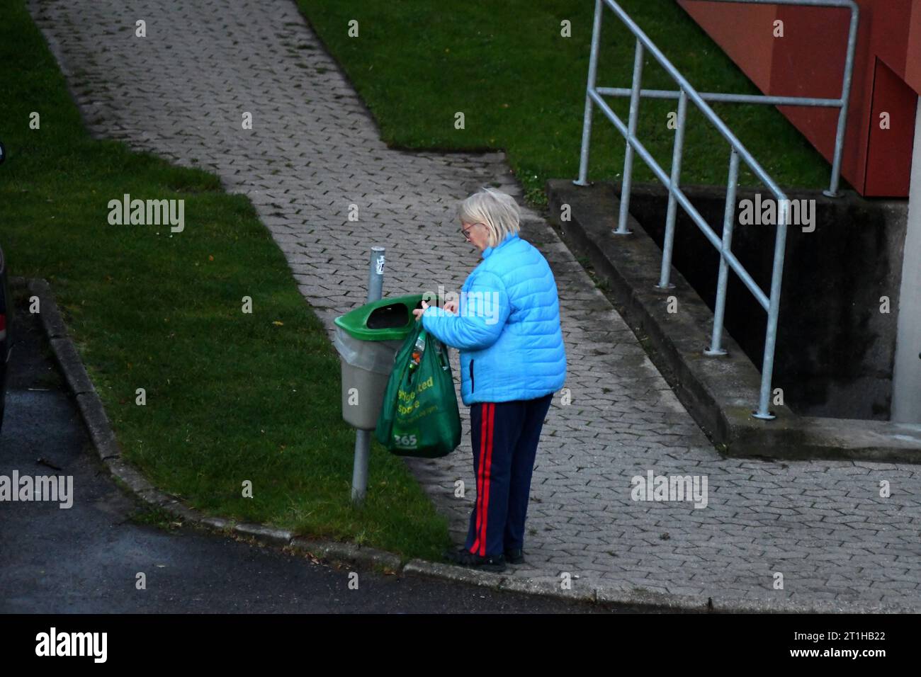 Copenhagen, Denmark /14 October. 2023/.Person seeks empty bottle and ...