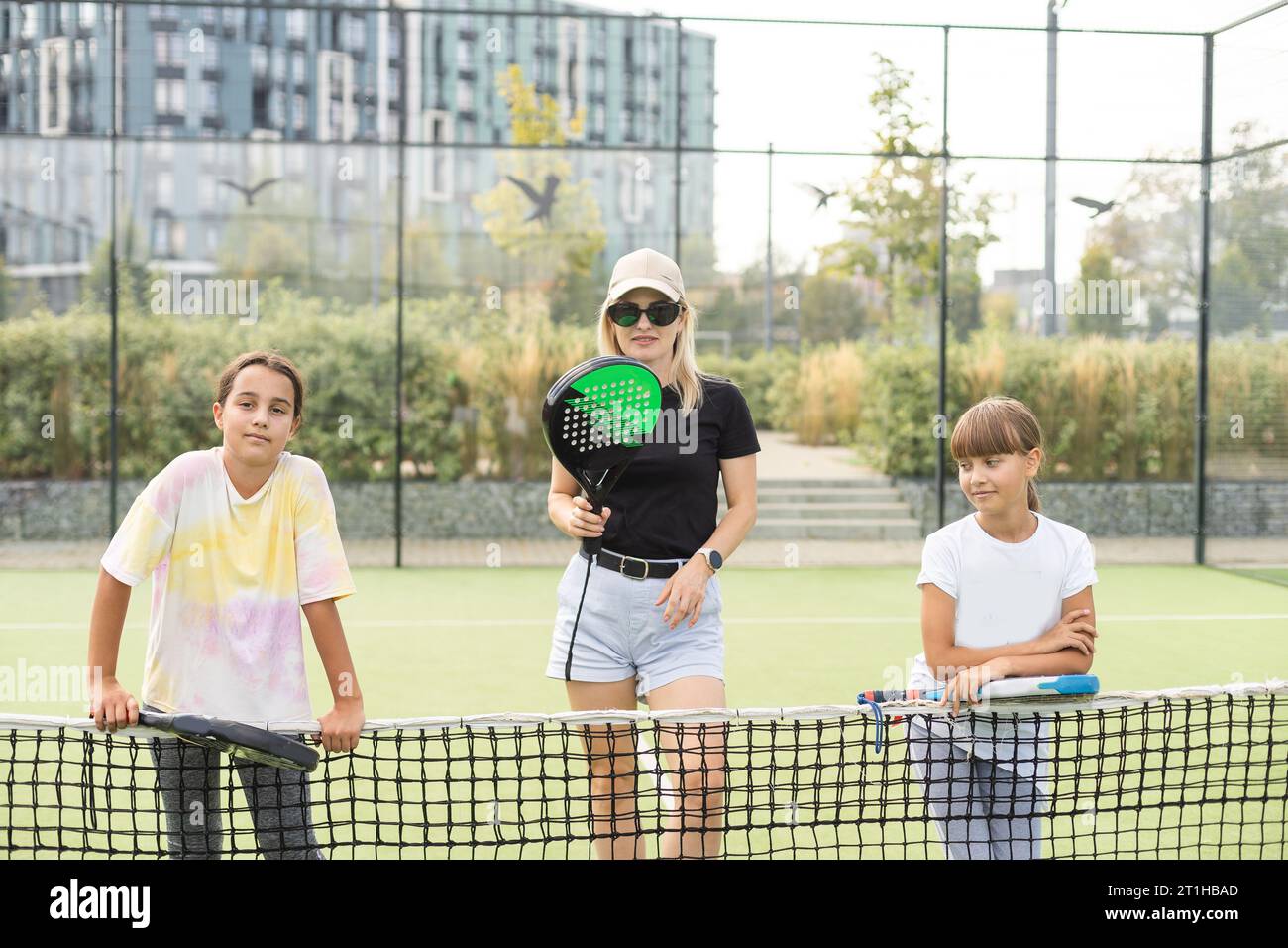 mother and daughters playing padel outdoor Stock Photo - Alamy