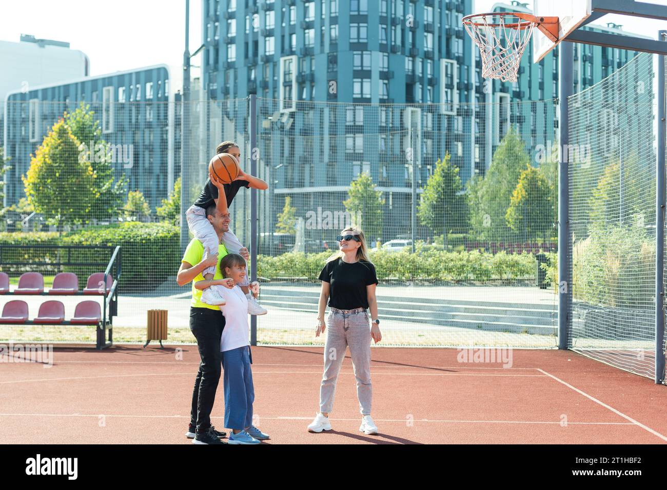 family playing basketball on court Stock Photo - Alamy