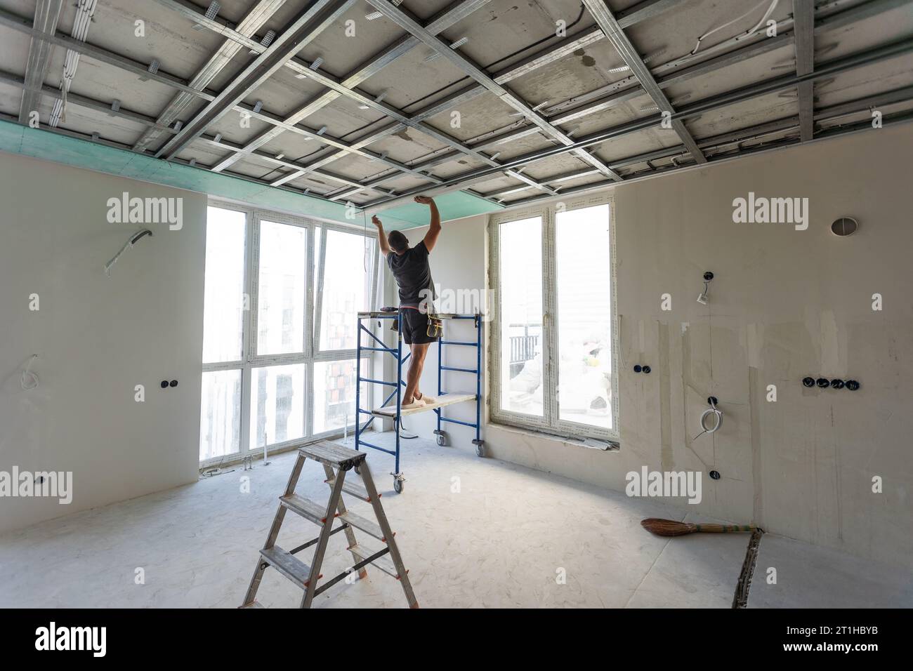 Drywall Installers. Men holding a gypsum board figured cut Stock Photo ...