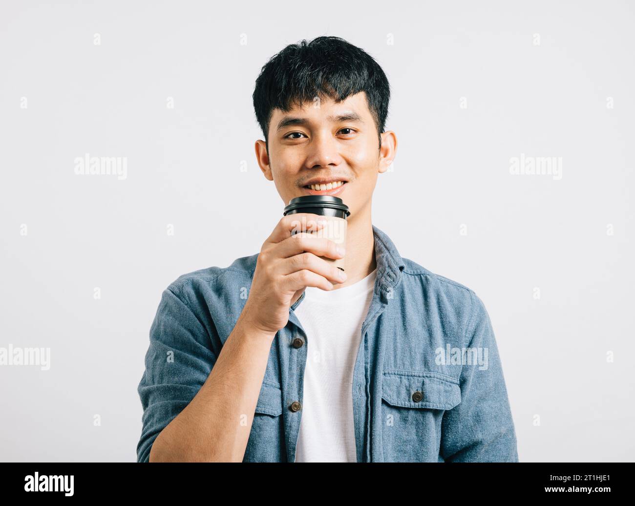 Smiling Thai man with take-away coffee cup in hand Stock Photo - Alamy