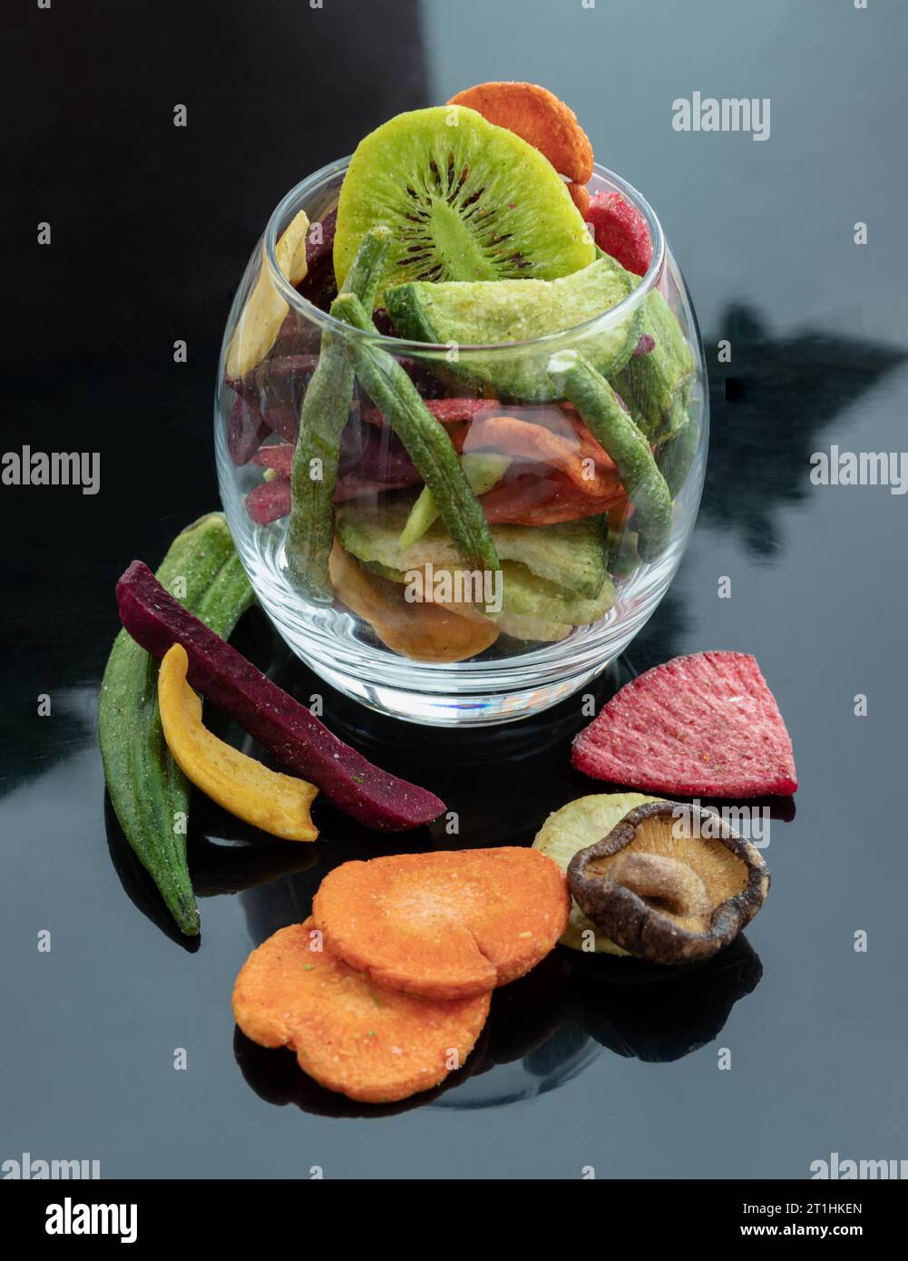 Different colorful dried fruits and vegetables in the glass. Crispy ...