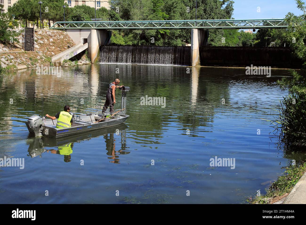 Removing algae with a machine in the Lez River. Philip Brothers Company ...