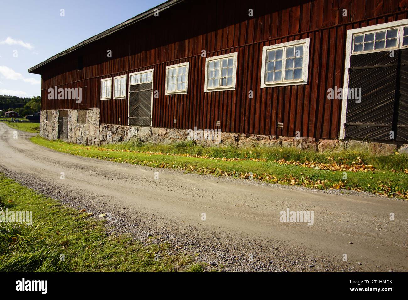 Red barn next to a road Stock Photo - Alamy