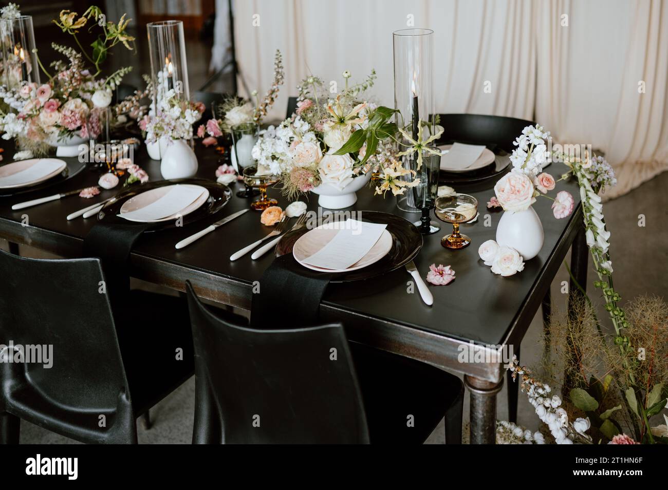 A celebratory wedding reception setup with elegant white china and ...