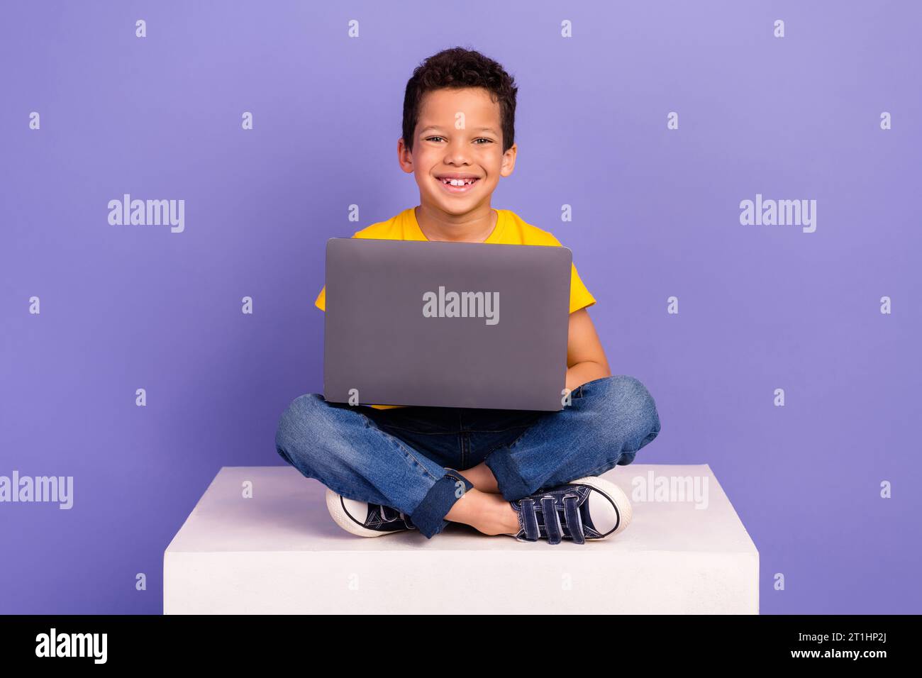 Full body photo of charming young boy sit white cube netbook remote ...