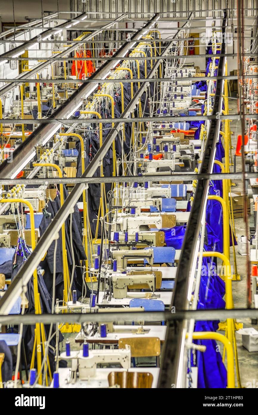 textile factory, indoors aerial view of the sewing machines and electric installation, african ...