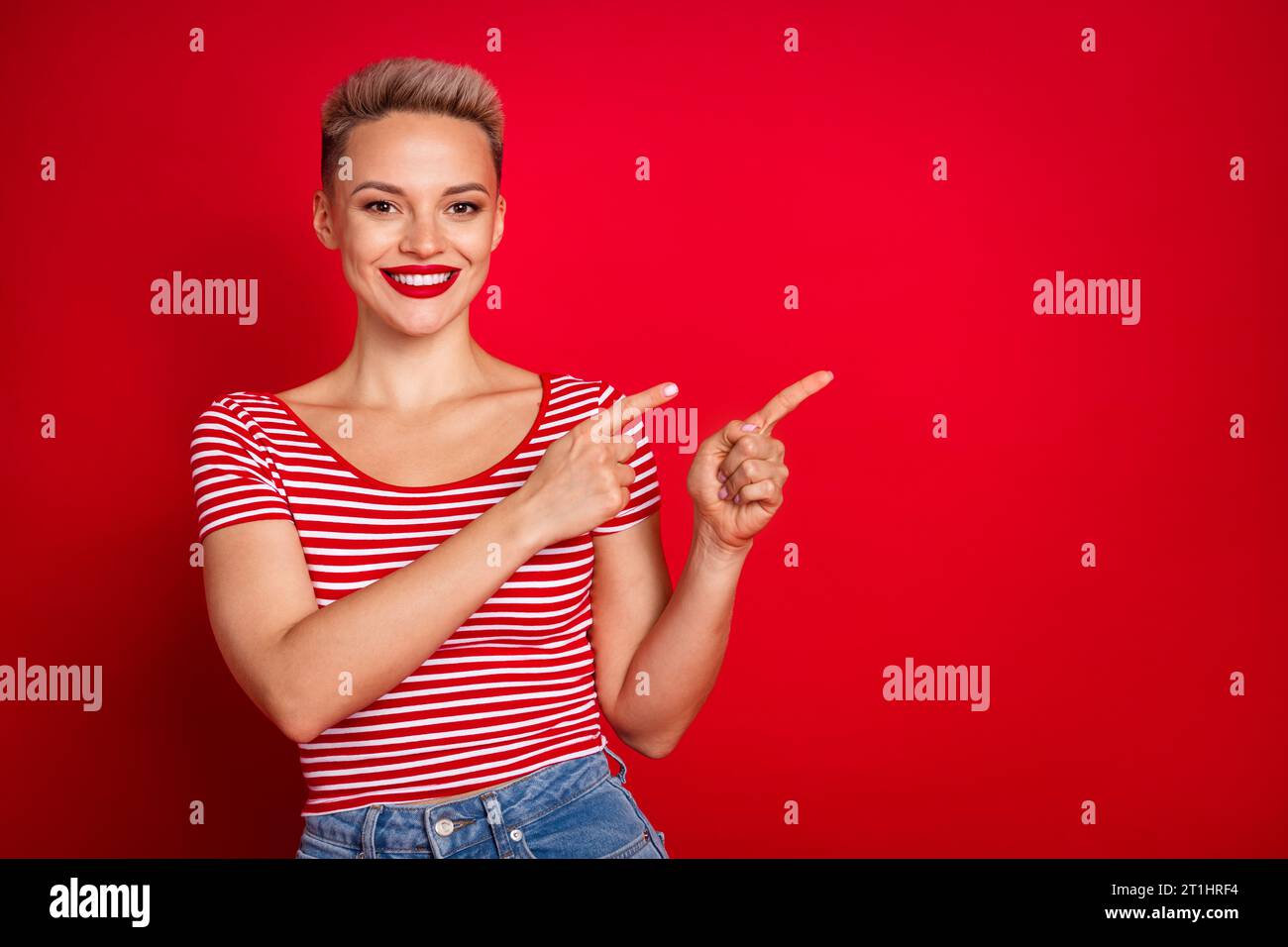 Photo of young lady short haircut pointing fingers empty space ...