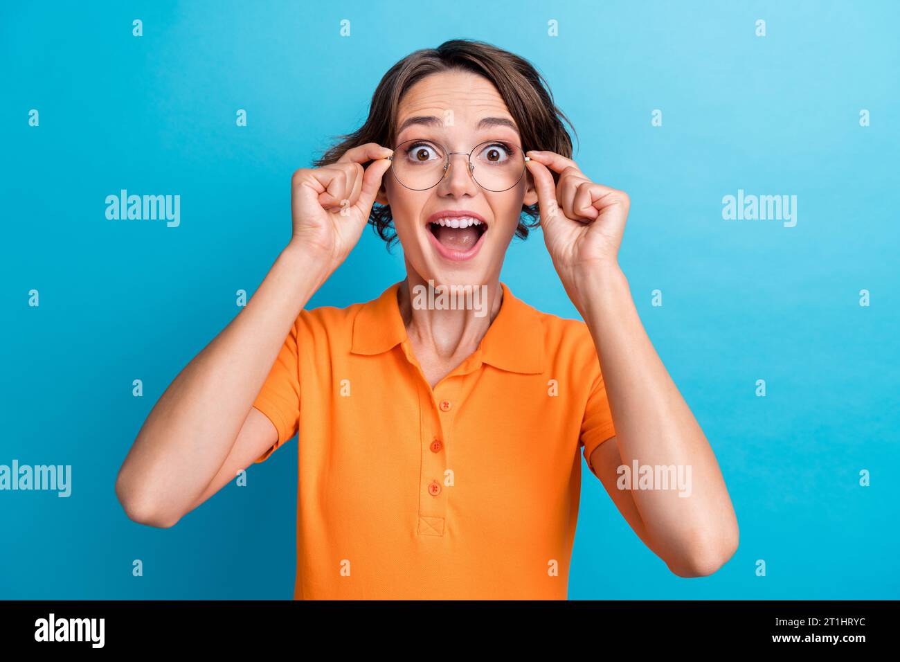 Photo of funky excited girl dressed orange arms eyewear open mouth ...