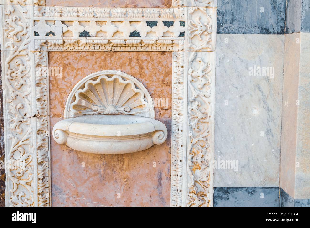 Tuscany: Old sculpture on medieval stone wall Stock Photo - Alamy