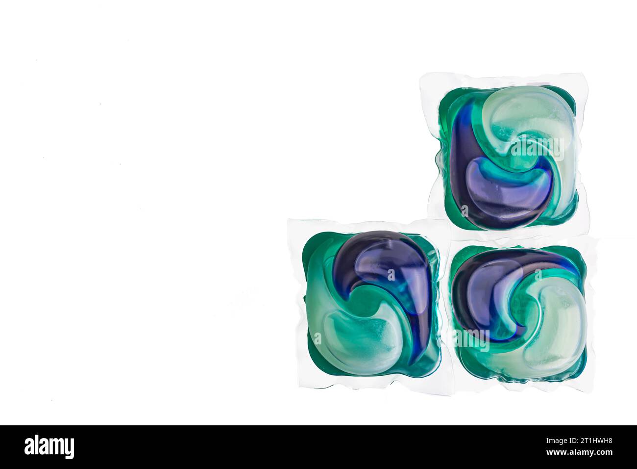 colored capsules for washing clothes on a white background close-up ...