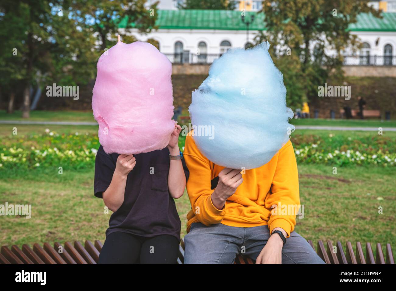 Two children are sitting with a large cotton candy blue and light blue ...