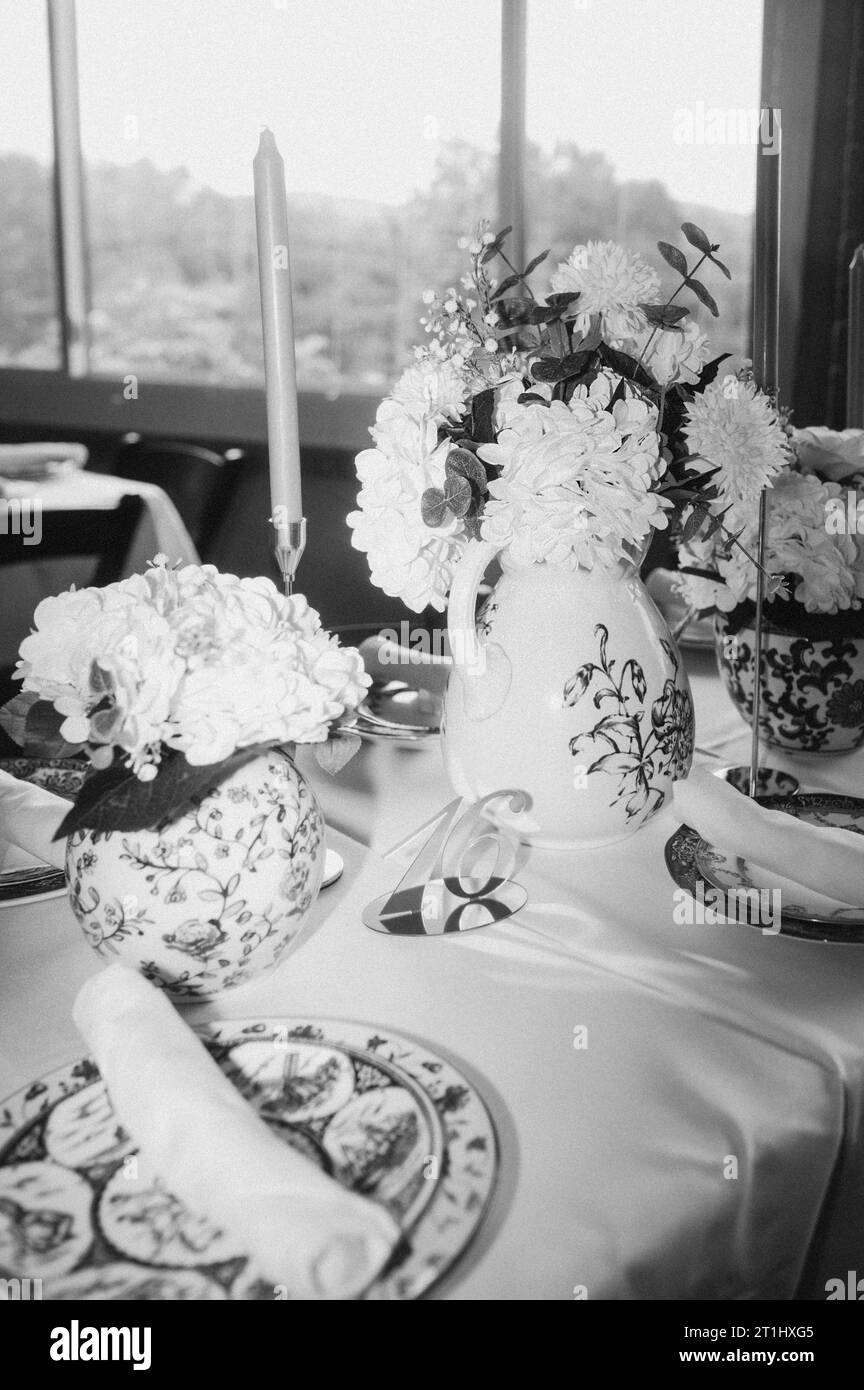 A black and white of a beautifully set dinner wedding table in front of ...