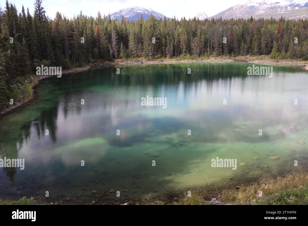 Lake Annette lake shore beach, Pyramid mountain reflection on the lake ...