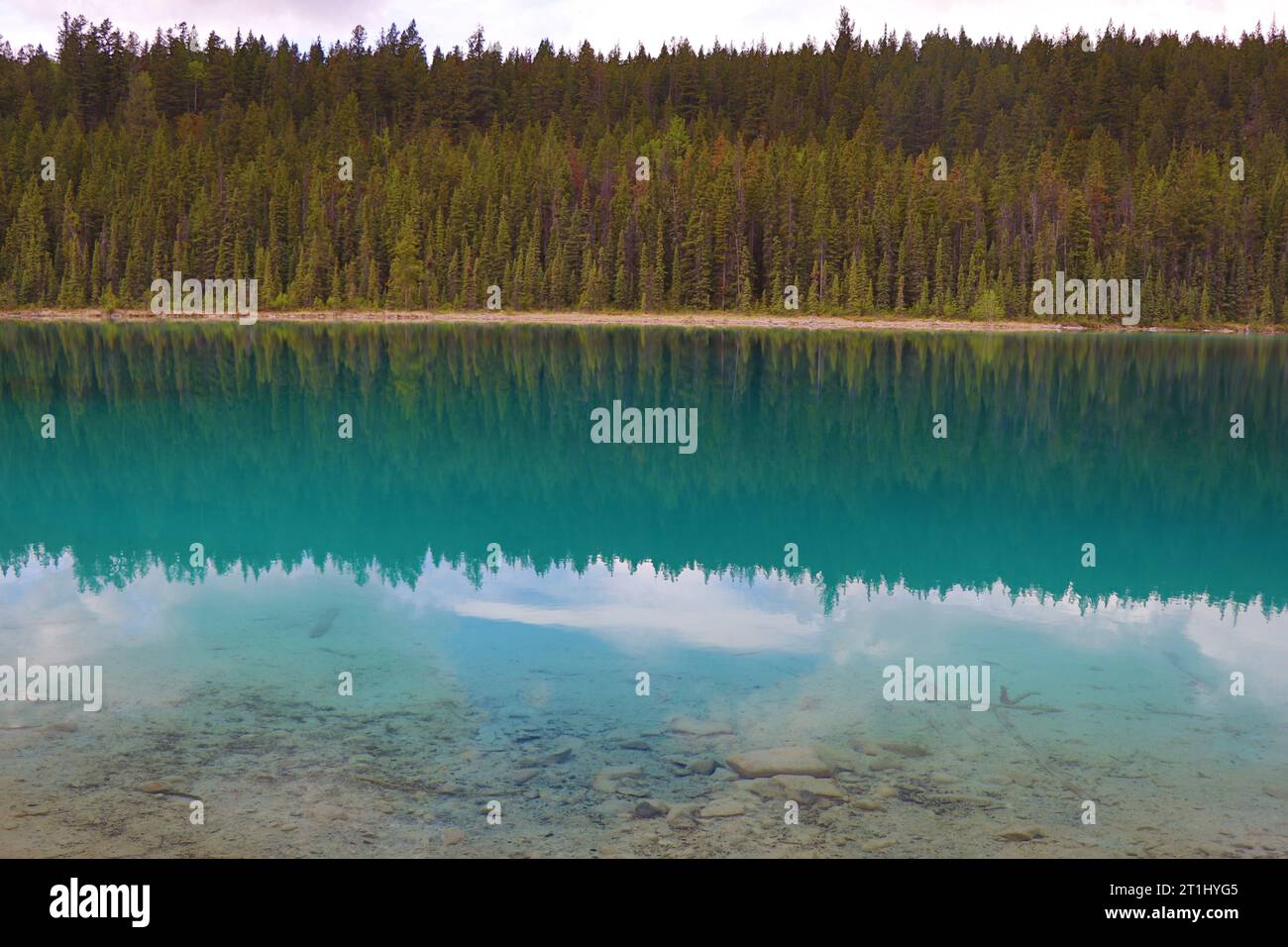 Lake Annette lake shore beach, Pyramid mountain reflection on the lake ...