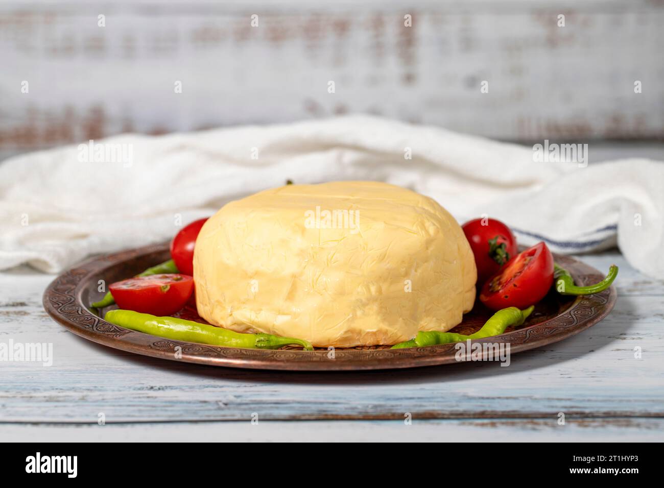 Butter in a copper plate. Organic fresh cow butter on wood background ...