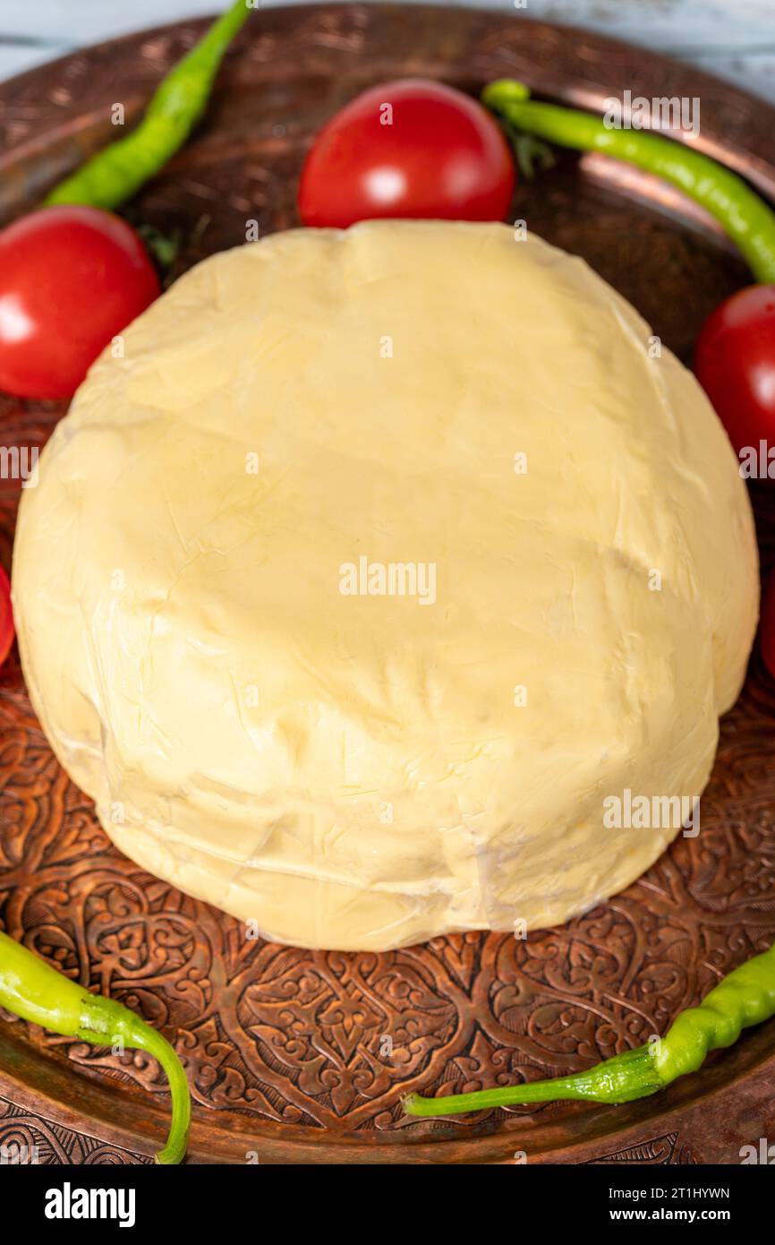 Butter in a copper plate. Organic fresh cow butter on wood background ...