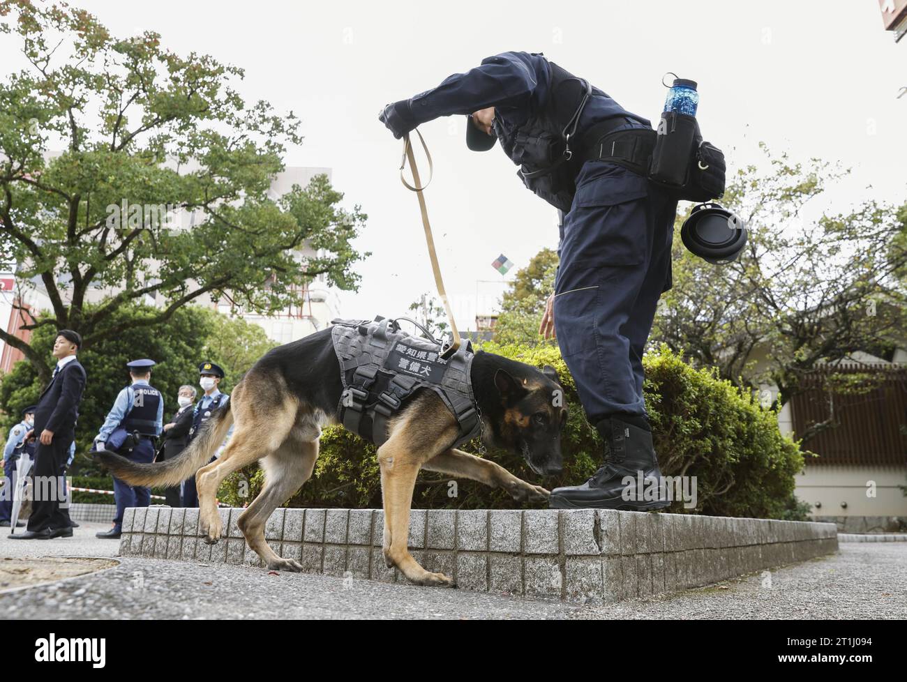 A police officer patrols with a security dog as Japanese Prime Minister ...