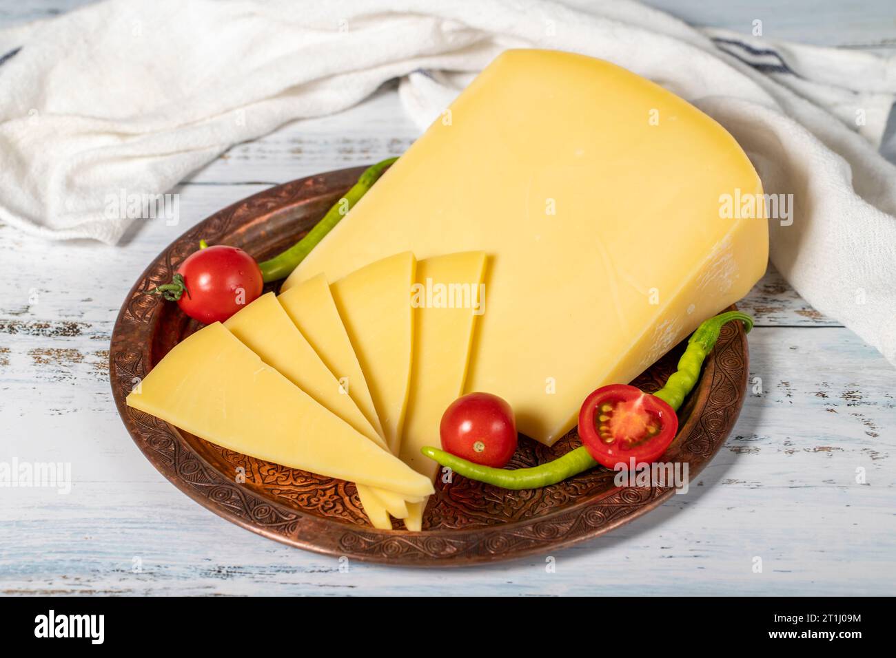 Aged cheese on a copper plate. Organic fresh cow cheddar on wood ...