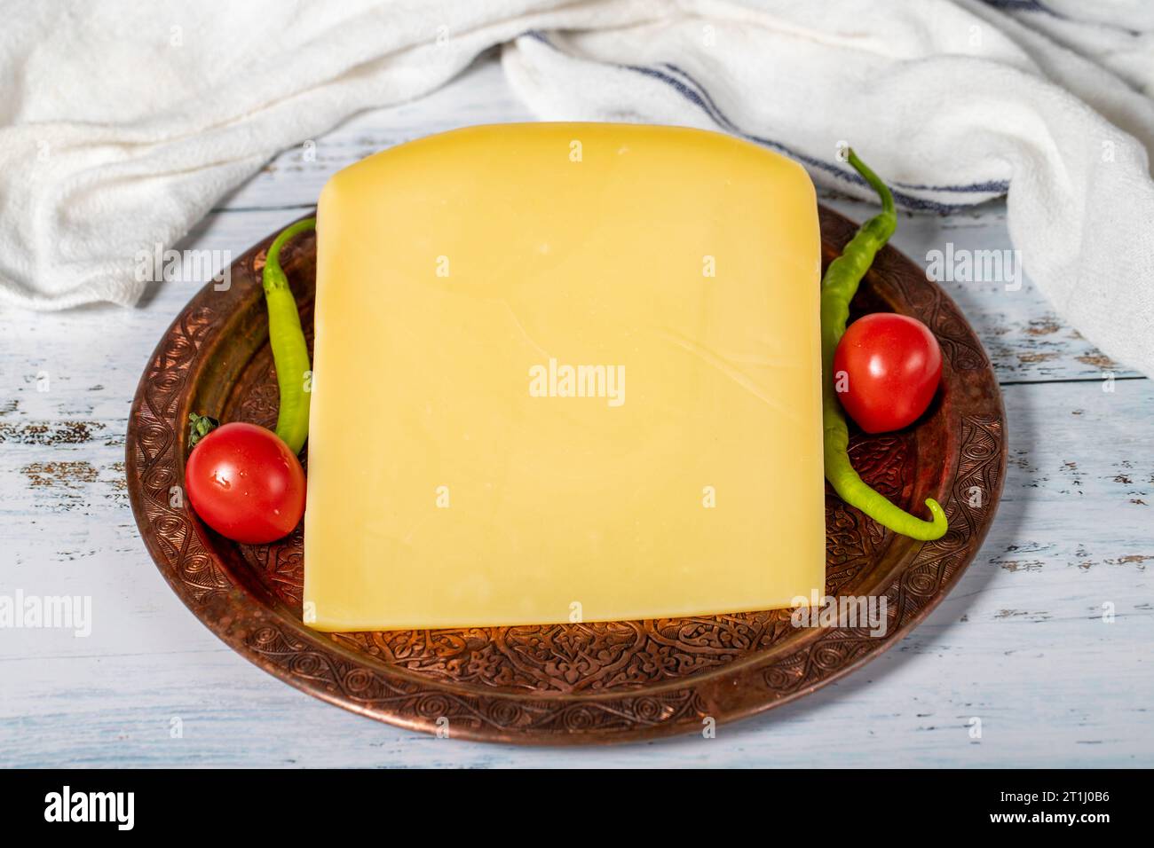 Aged cheese on a copper plate. Organic fresh cow cheddar on wood ...