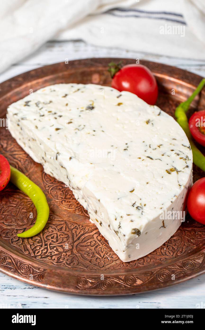 Herb cheese on a copper plate. Slices of herbed cheese on wooden ...