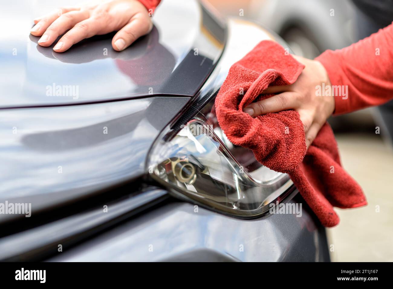 polishing a car with a rag after the car wash Stock Photo - Alamy
