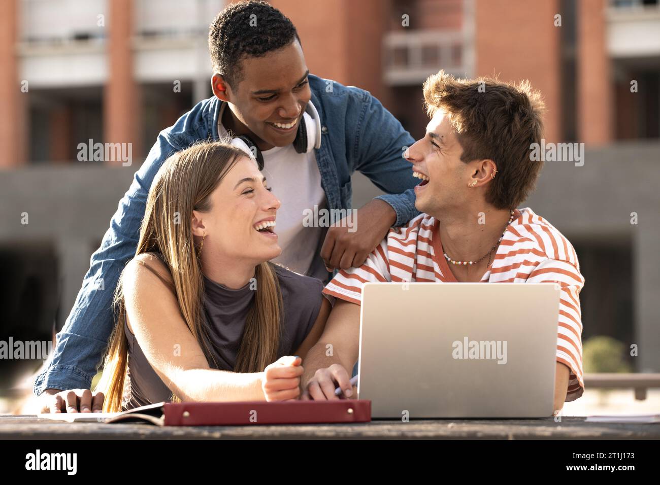 Cheerful multiracial friends using laptop hi-res stock photography and ...
