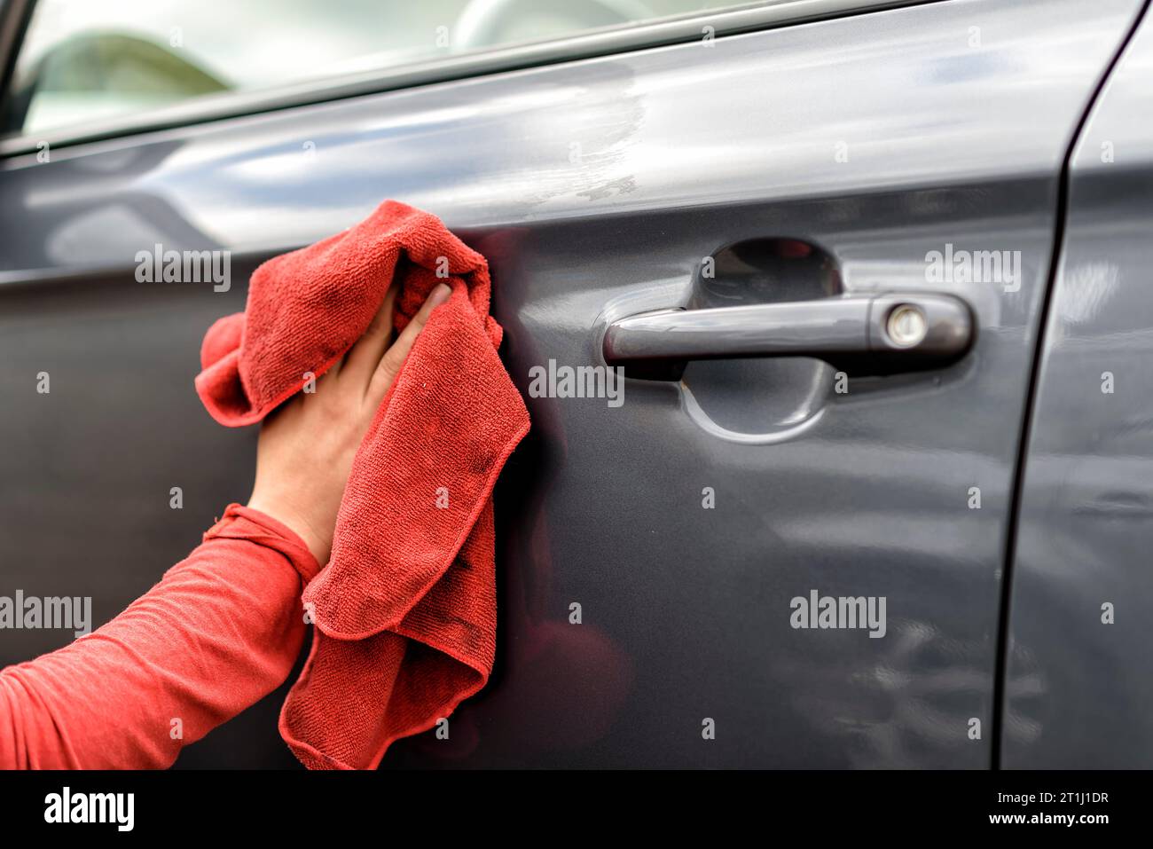 polishing a car with a rag after the car wash Stock Photo - Alamy