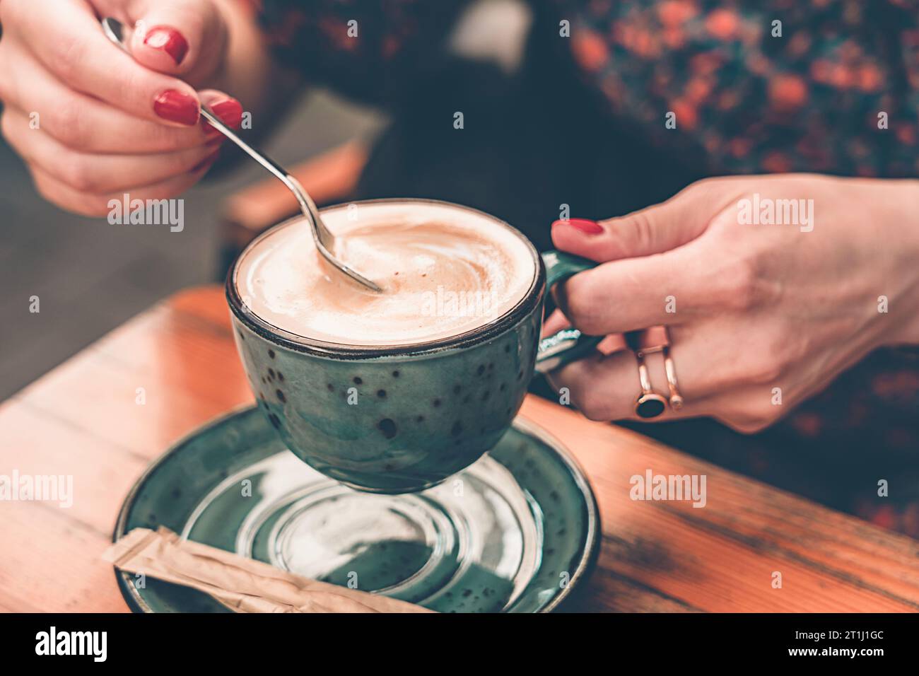 Hand stirs cappuccino coffee hi-res stock photography and images - Alamy