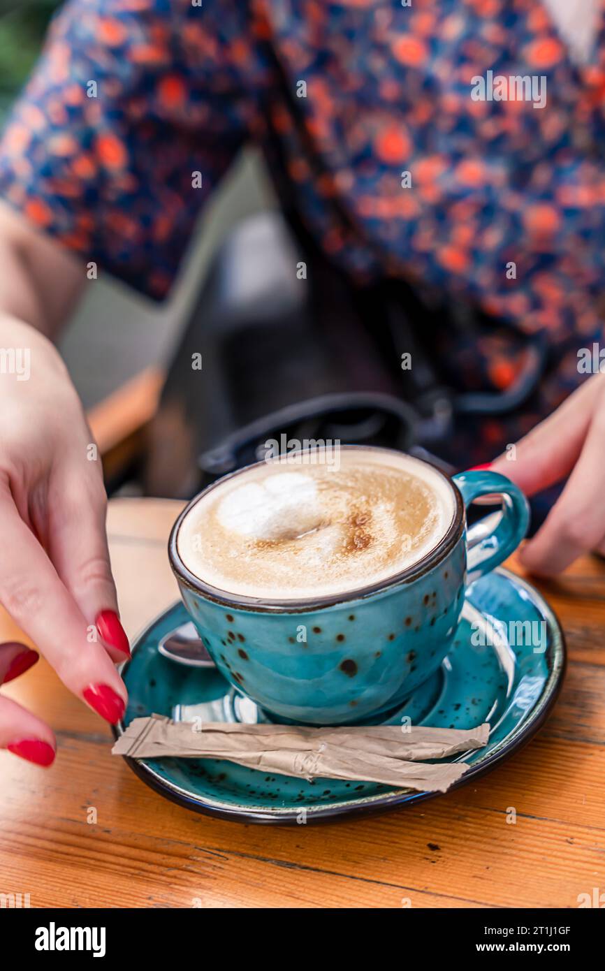 Hand stirs cappuccino coffee hi-res stock photography and images - Alamy
