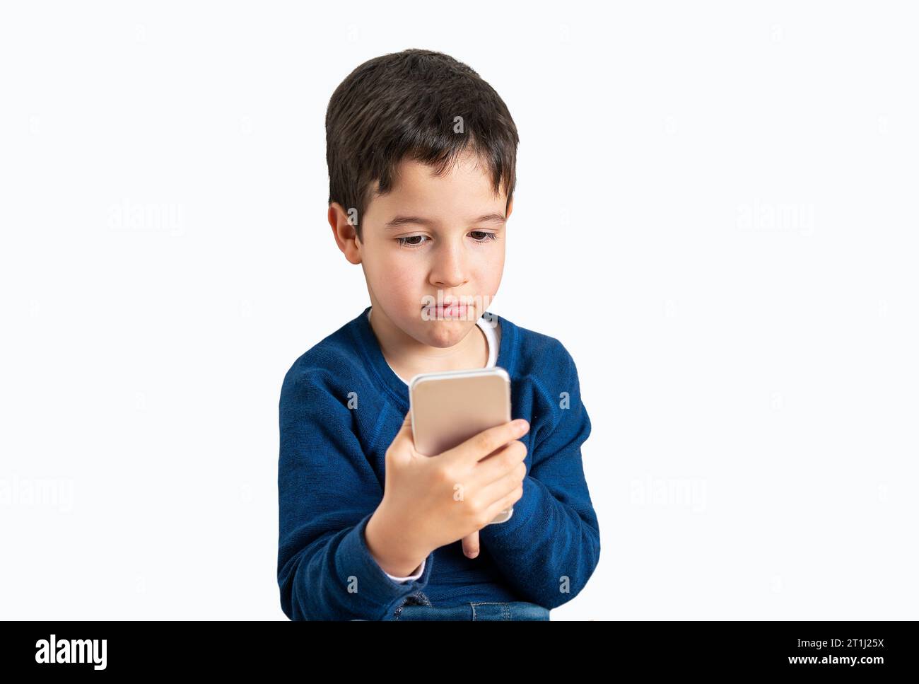 Little boy with his phone. A little boy playing with a smartphone with ...