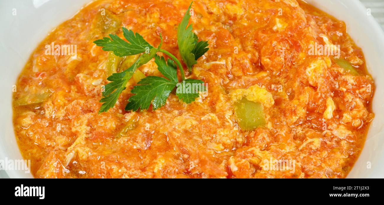 One of the most eaten dishes of Turkish cuisine is menemen, isolated on ...