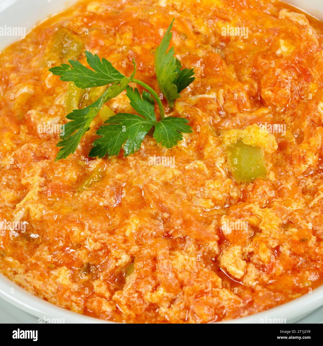One of the most eaten dishes of Turkish cuisine is menemen, isolated on ...
