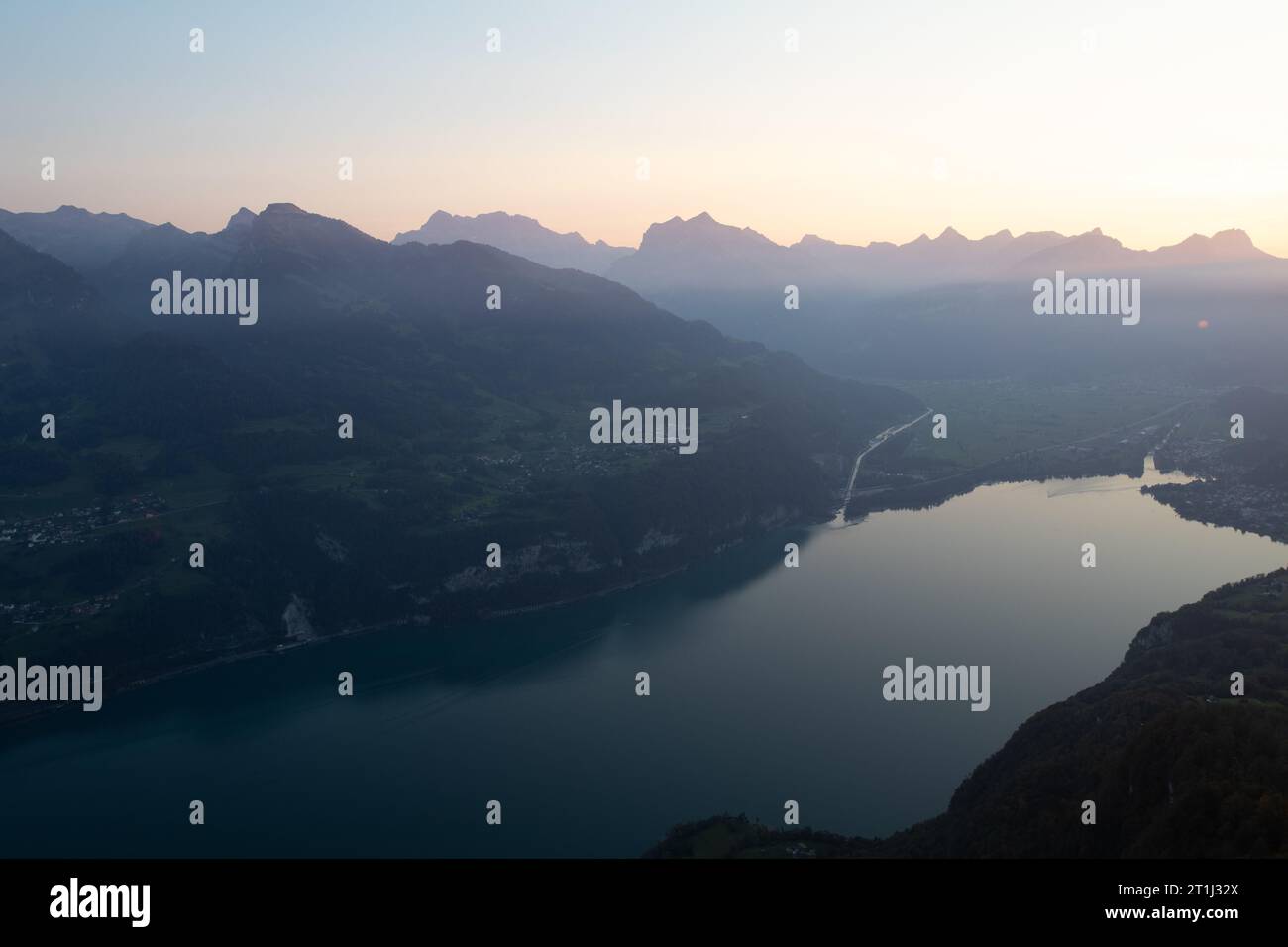 Walensee Lake in a winter morning at sunrise time with floating foggy ...