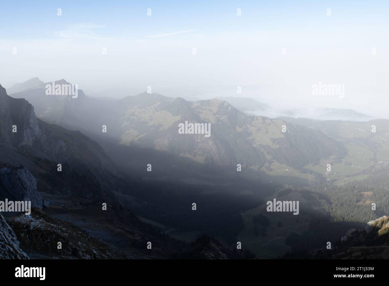 Walensee Lake in a winter morning at sunrise time with floating foggy ...