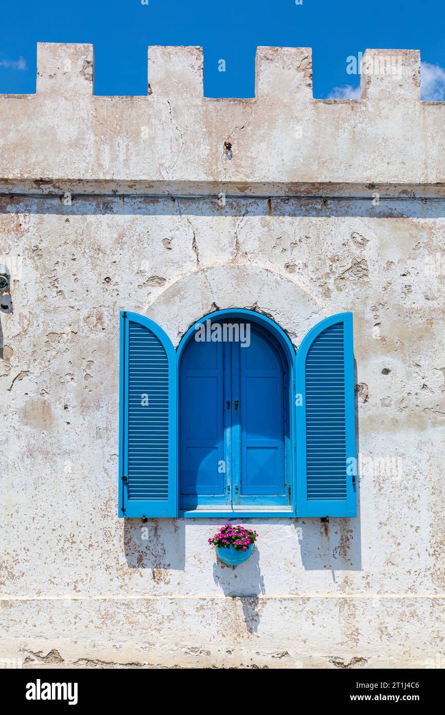 A window with blue shutters in Santa Maria di Leuca, a village on the ...