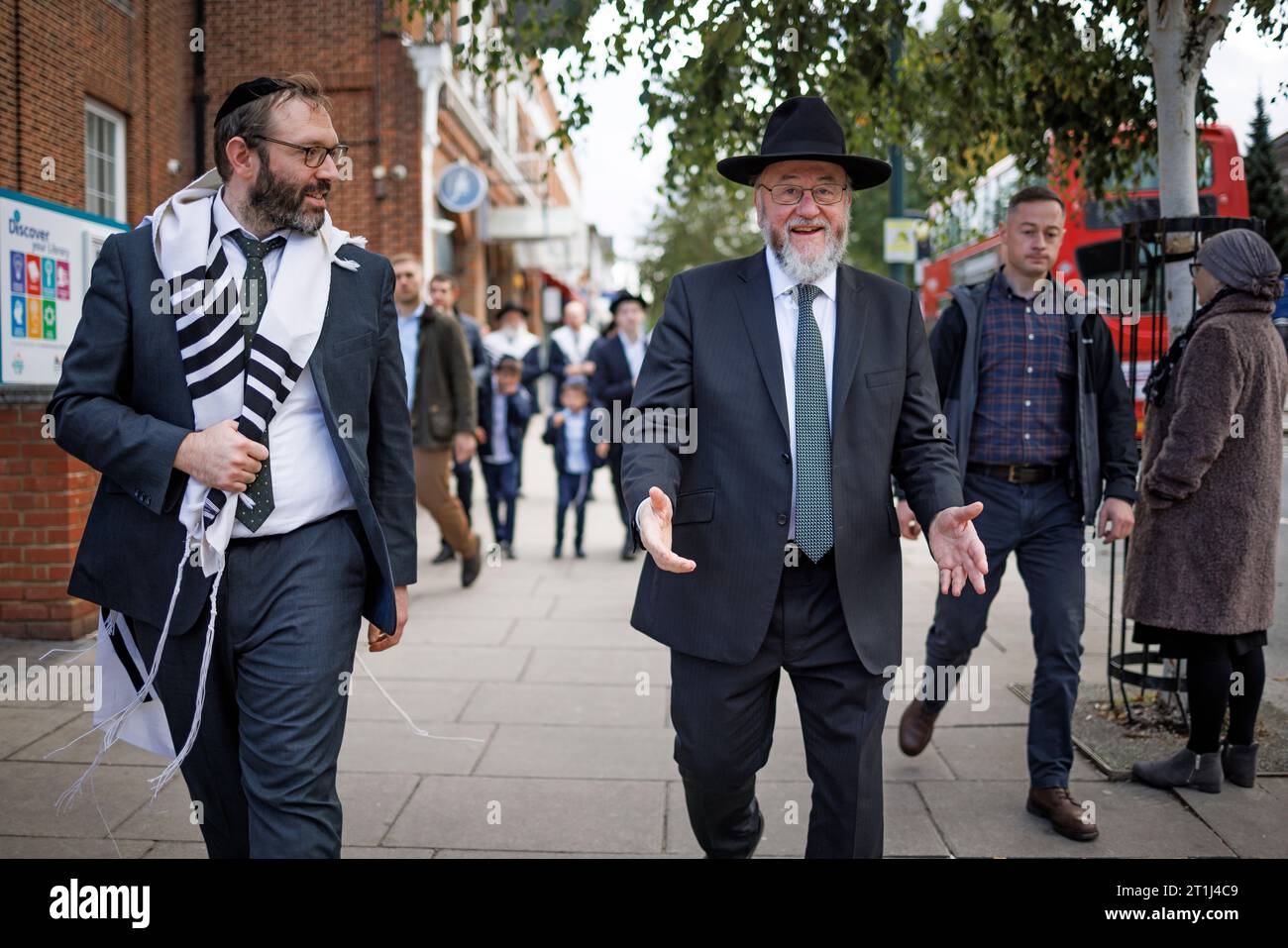 London, UK. 14th Oct, 2023. Chief Rabbi Ephraim Mirvis (right) is seen ...