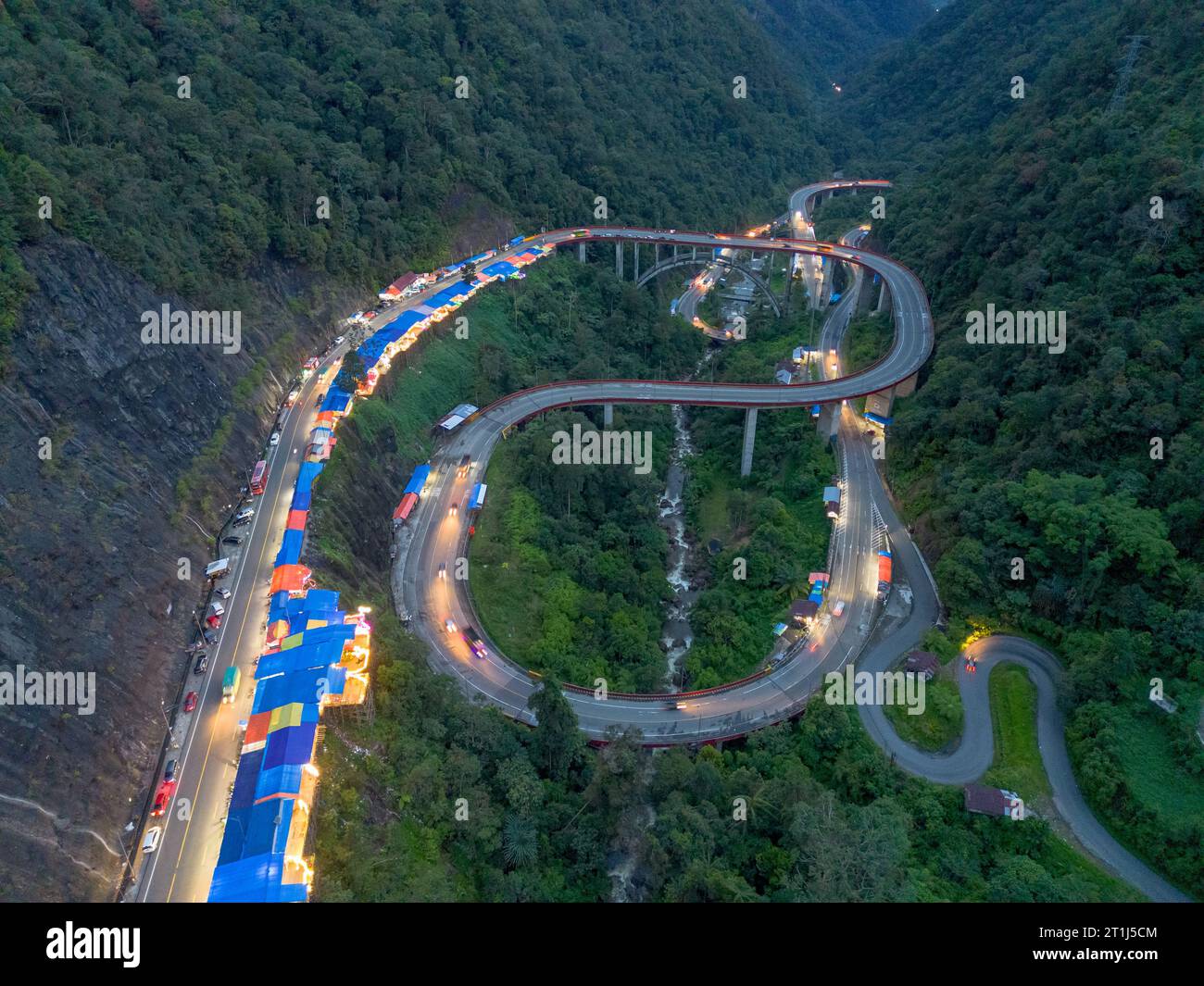Aerial view of Kelok 9 bridge at dusk. A popular bridge in Sumatra to ...