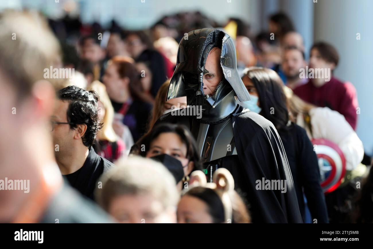An attendee dressed as Darth Vader waits in line during New York Comic ...