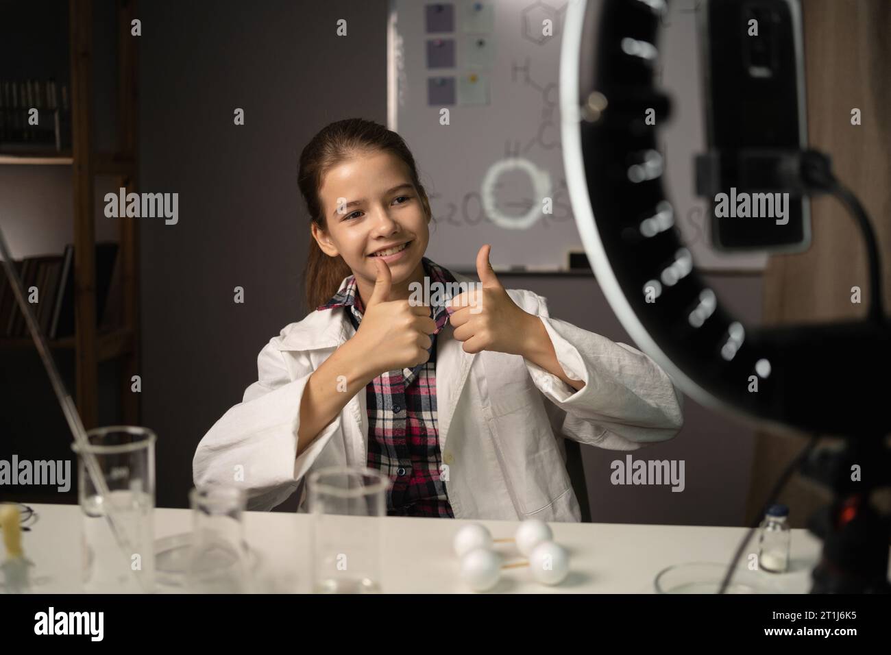 Science student girl recording learning blog showing thumbs-up on ...