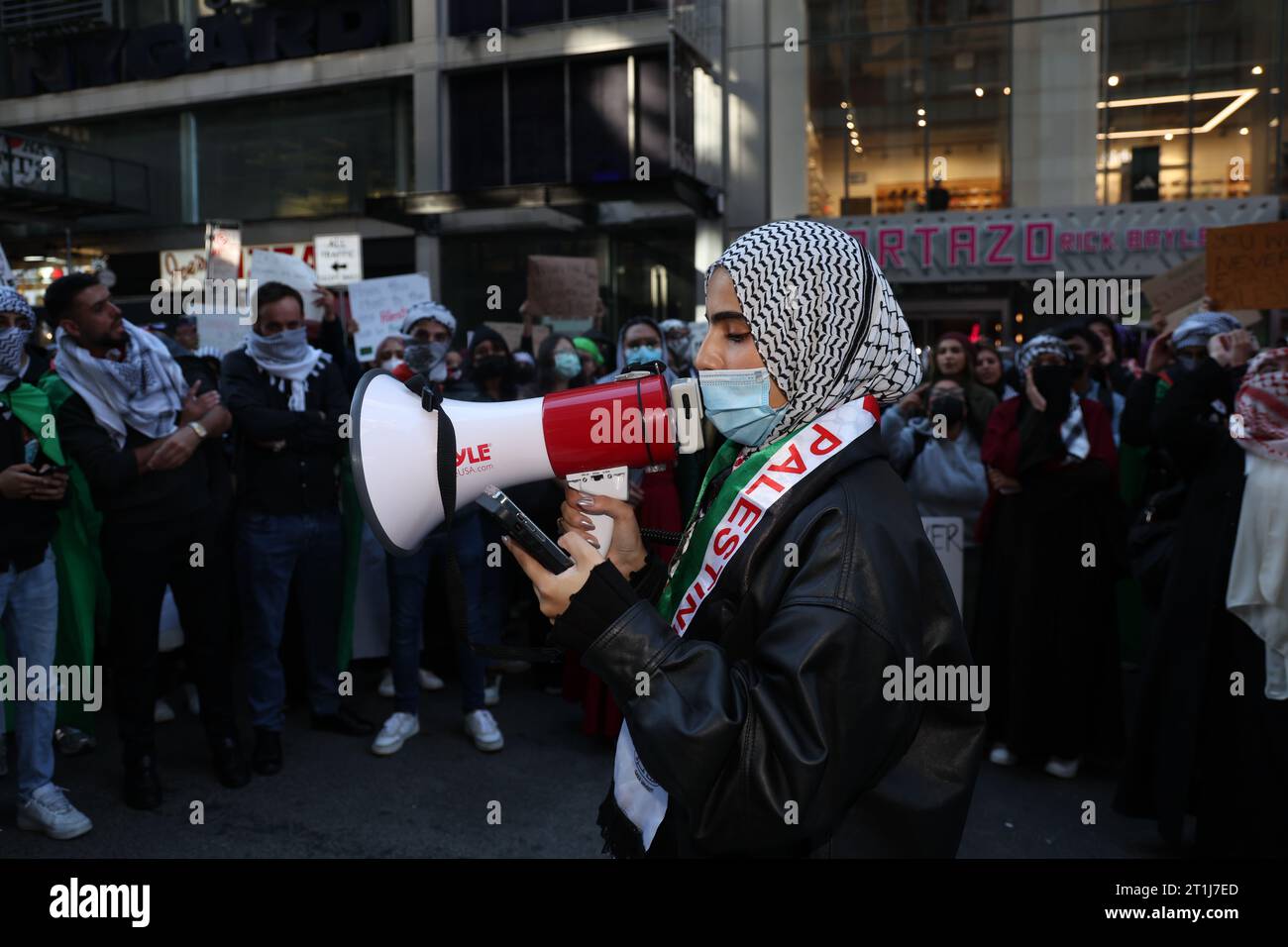 A woman reads statements into a megaphone as Palestinian supporters ...