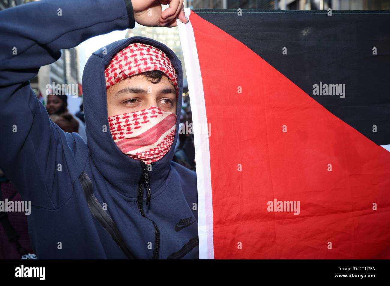 A young man carries a flag of Palestine as supporters gather at Times ...