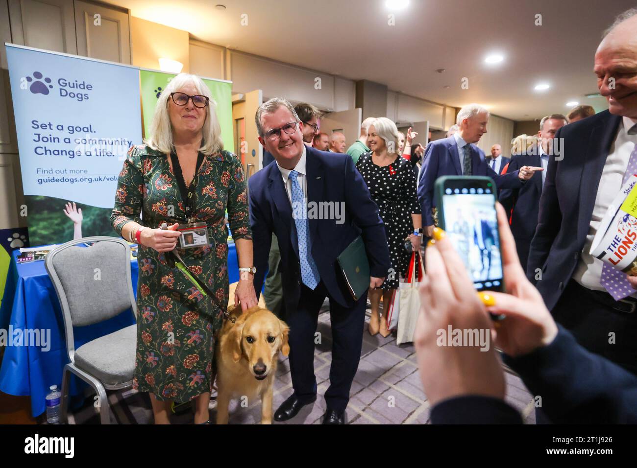 DUP leader Sir Jeffrey Donaldson (second left) poses with Guide Dogs ...