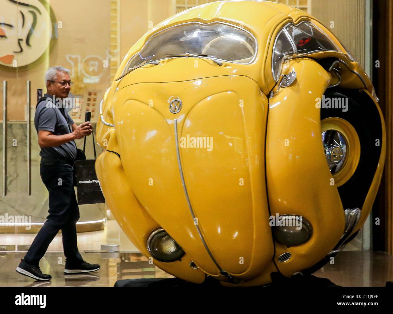 Taguig City, Philippines. 13th Oct, 2023. A man takes photos of an art ...