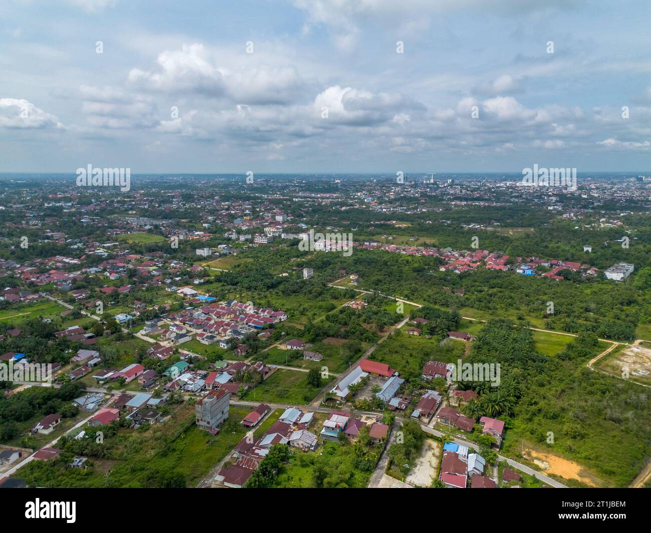 Aerial View of Pekanbaru city skyline with many trees in Indonesia. The ...