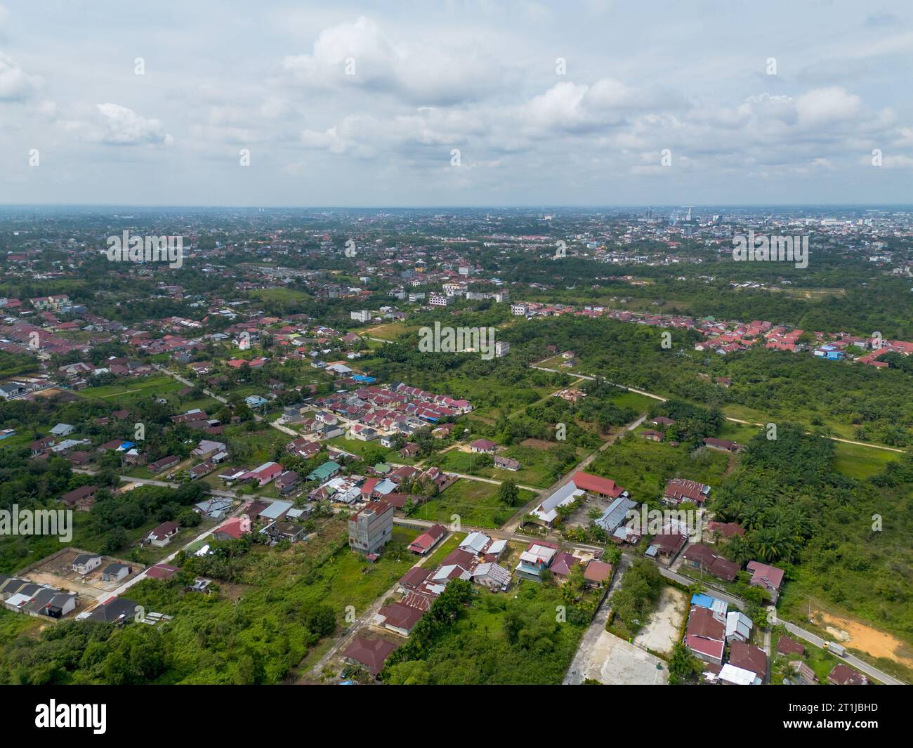 Aerial View of Pekanbaru city skyline with many trees in Indonesia. The ...