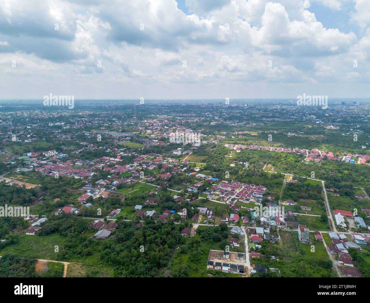 Aerial View of Pekanbaru city skyline with many trees in Indonesia. The ...