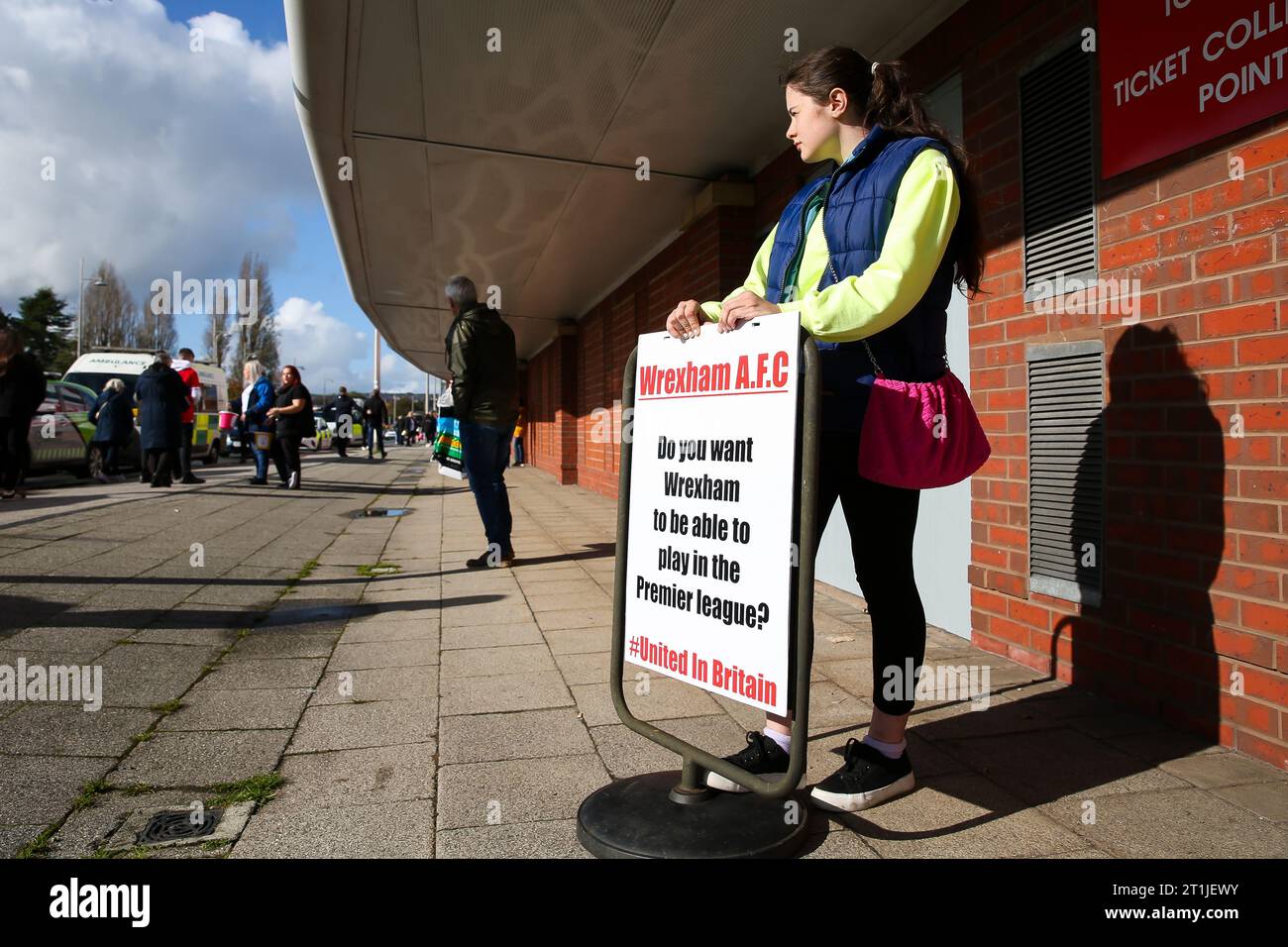 A female with a banner asking fans about Wrexham in the Premier league ...