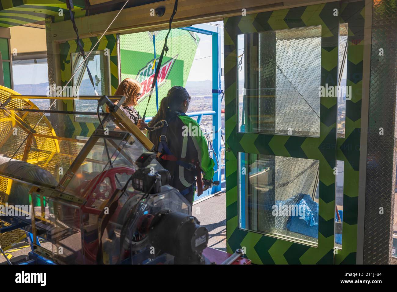 Tourist and woman instructor on open desk Sky Pod before jump. Strat ...